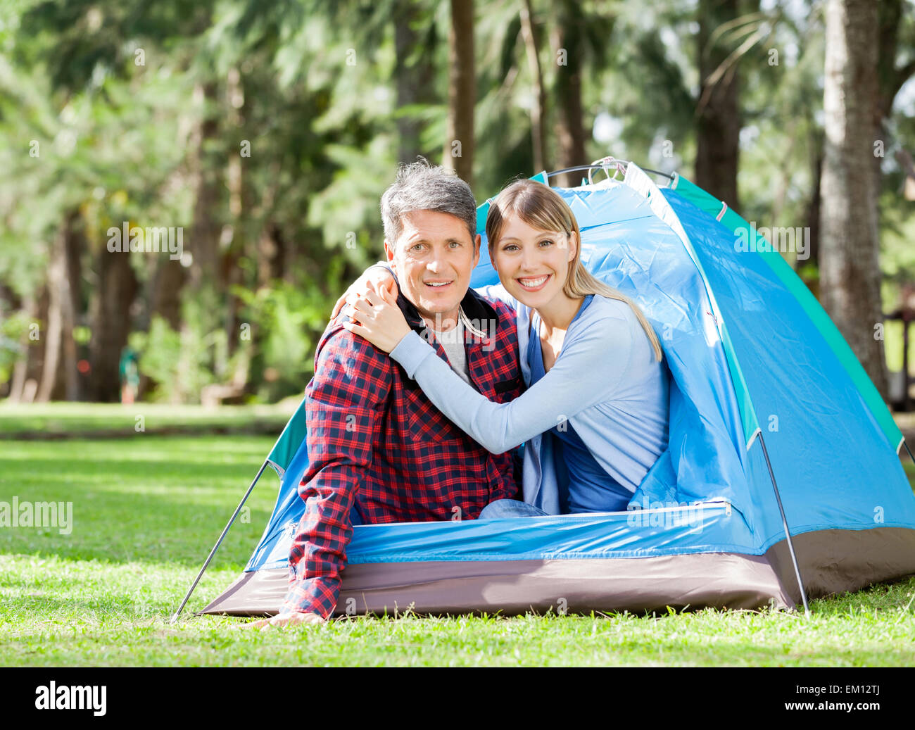 Loving Couple Sitting In Tent At Park Stock Photo - Alamy