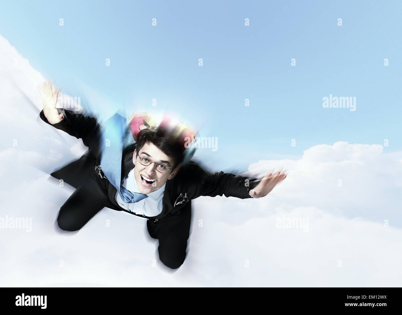 Young businessman flying with parachute on back Stock Photo - Alamy