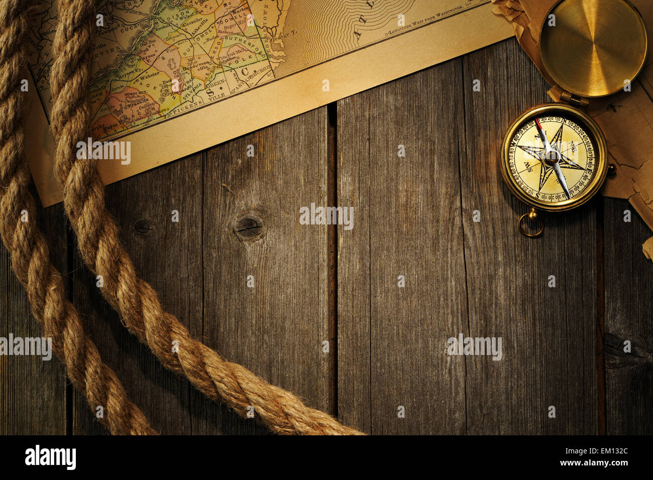 Antique compass and rope over old map Stock Photo - Alamy