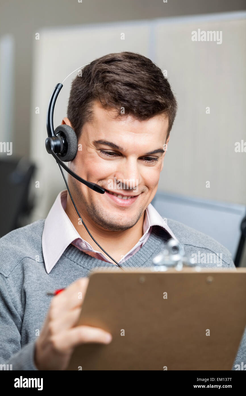 Smiling Customer Service Representative Wearing Headset While Ho Stock ...