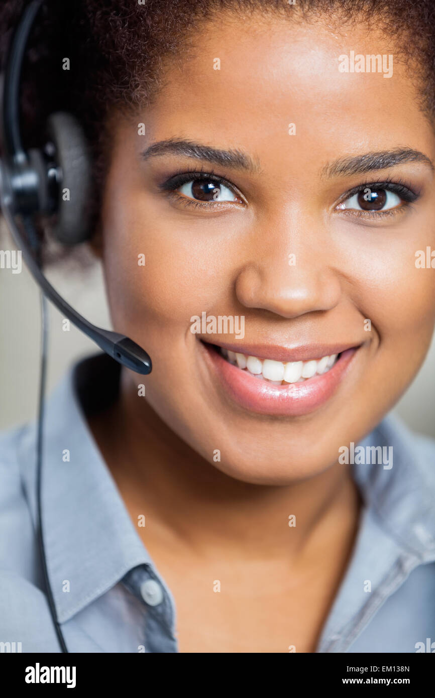 Portrait Of Young Female Customer Service Agent Wearing Headset Stock ...