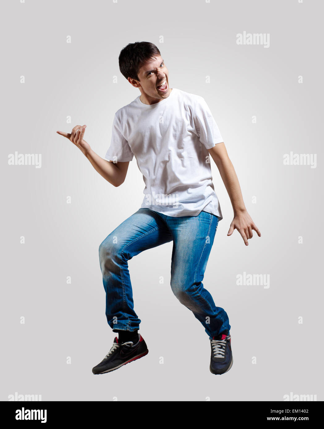 Young man dancing and jumping Stock Photo - Alamy