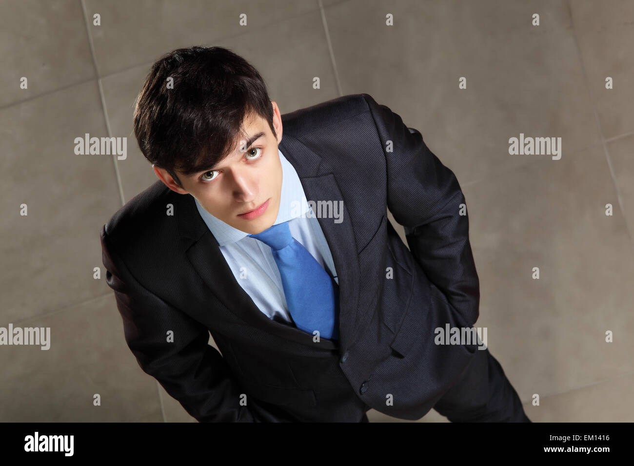Young businessman looking above Stock Photo - Alamy