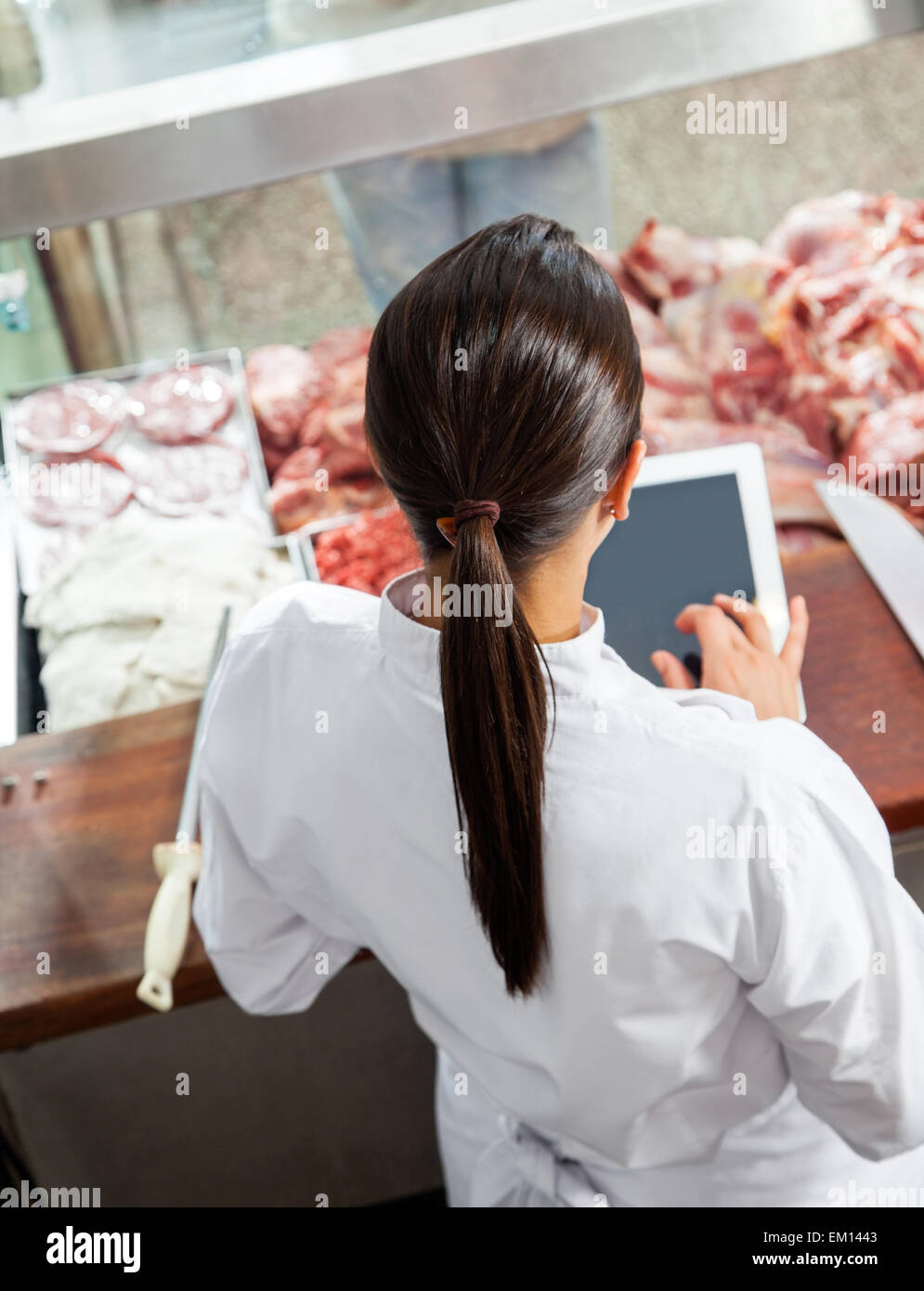 Butcher Using Digital Tablet In Butchery Stock Photo - Alamy