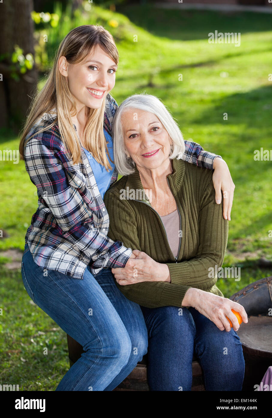 Daughter Embracing Mother Sitting On Chair At Campsite Stock Photo - Alamy
