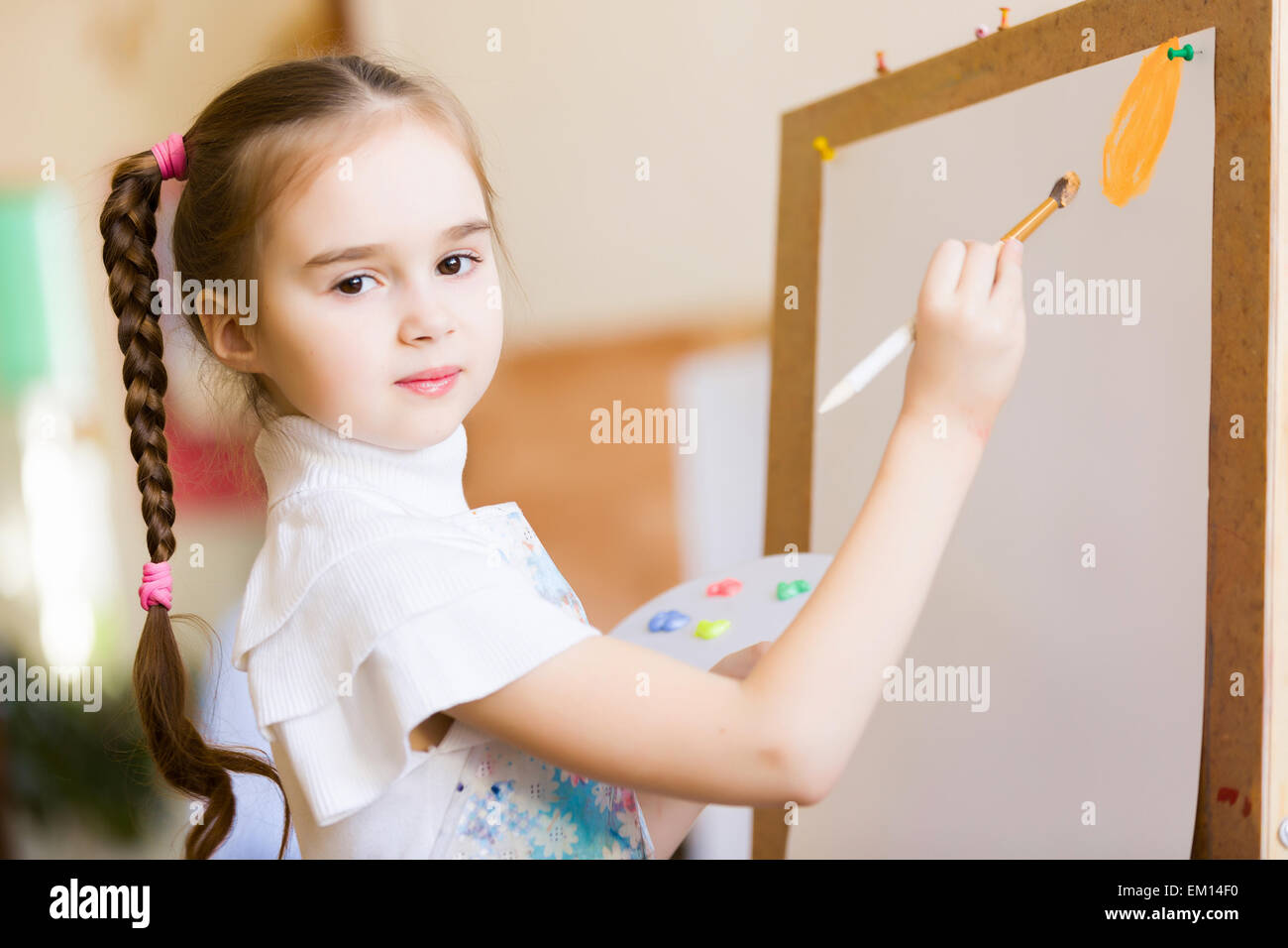 Cute girl painting Stock Photo - Alamy