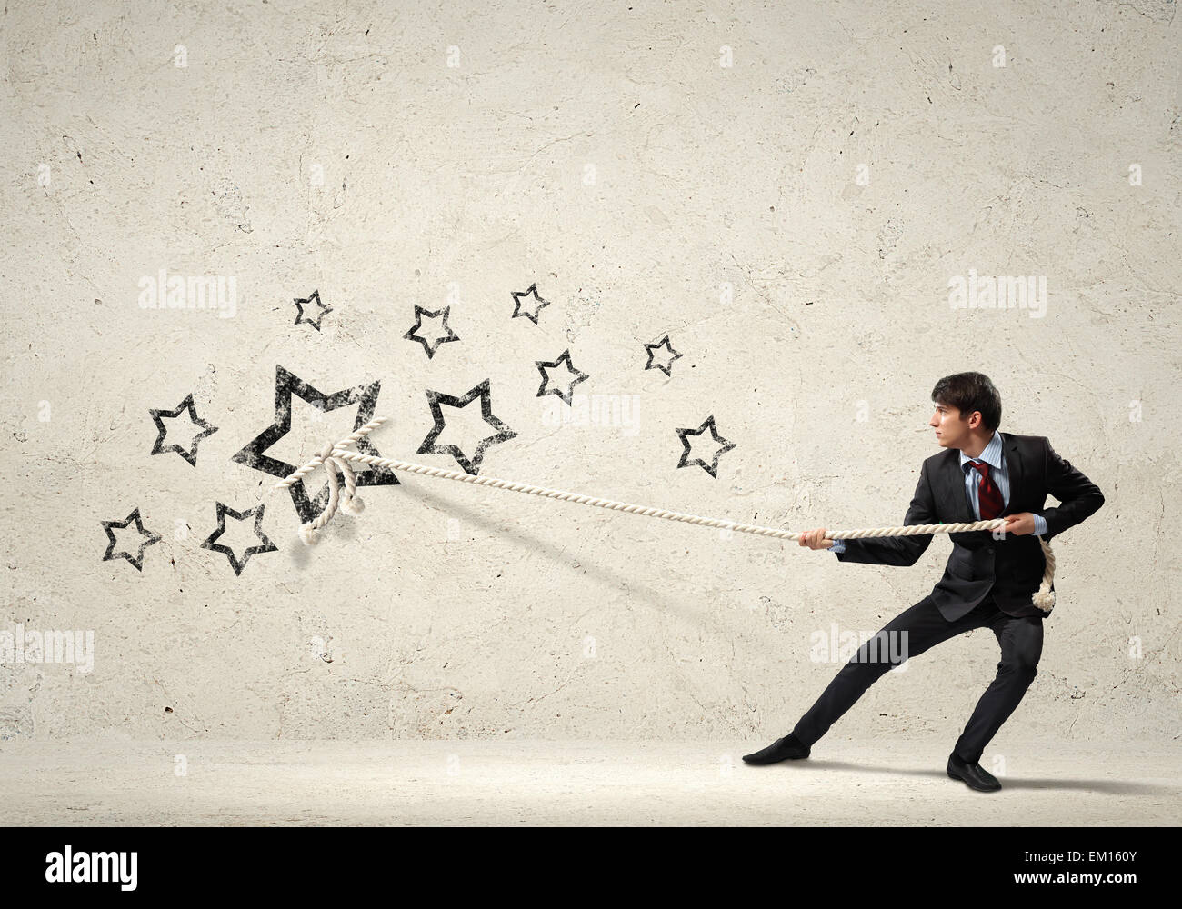 Businessman pulling rope Stock Photo - Alamy