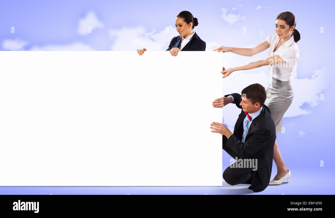 Three young people holding banner Stock Photo - Alamy