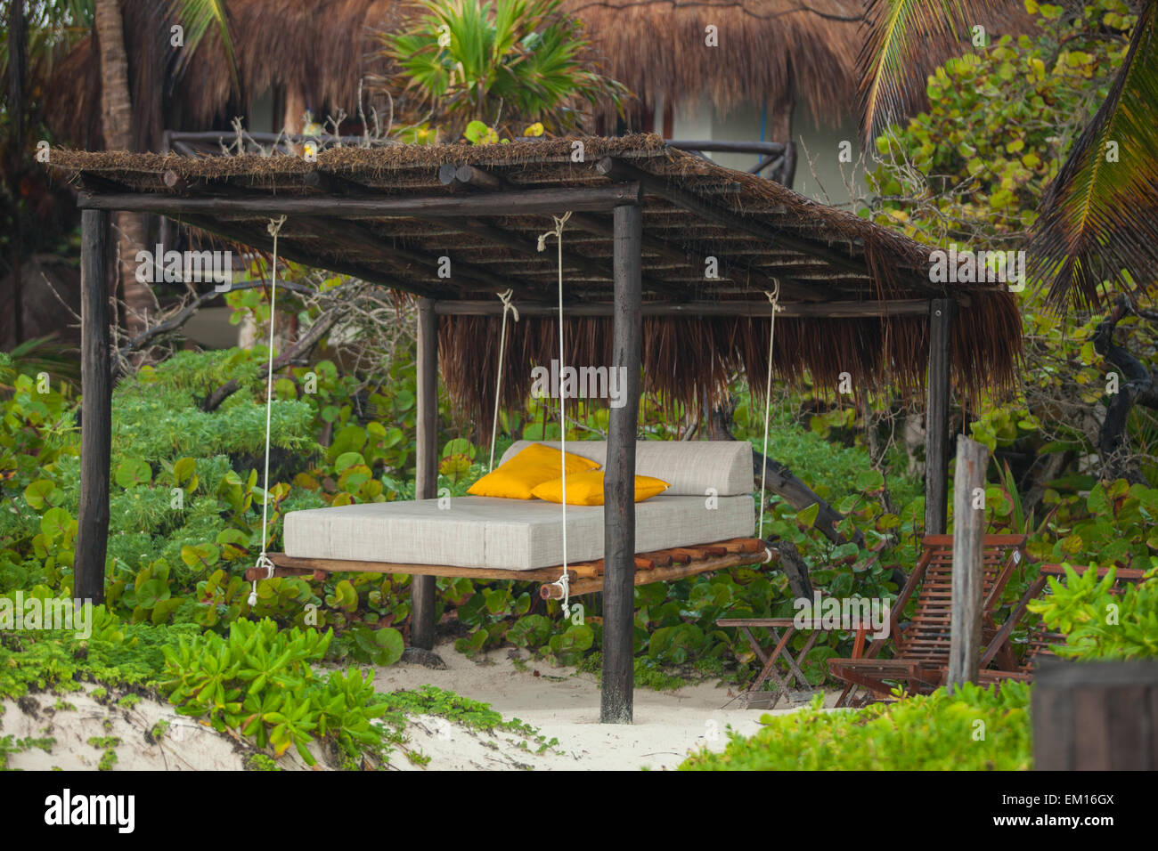 Beach beds among the trees at tropical exotic white plage Stock Photo ...