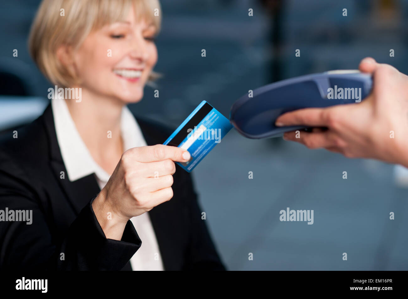 Corporate lady swiping her card to pay Stock Photo - Alamy