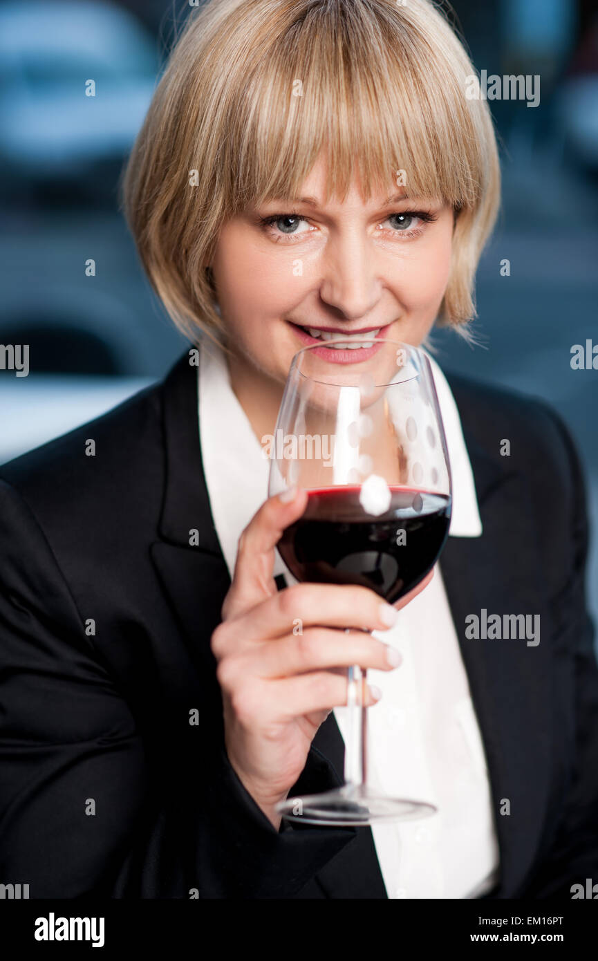 Corporate lady drinking red wine Stock Photo - Alamy