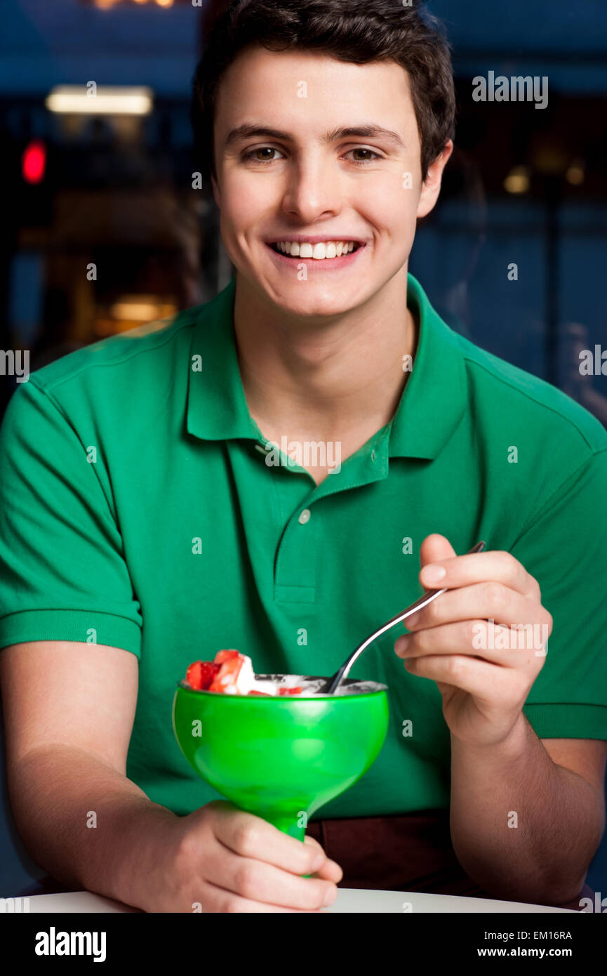 Young chap eating ice cream Stock Photo - Alamy
