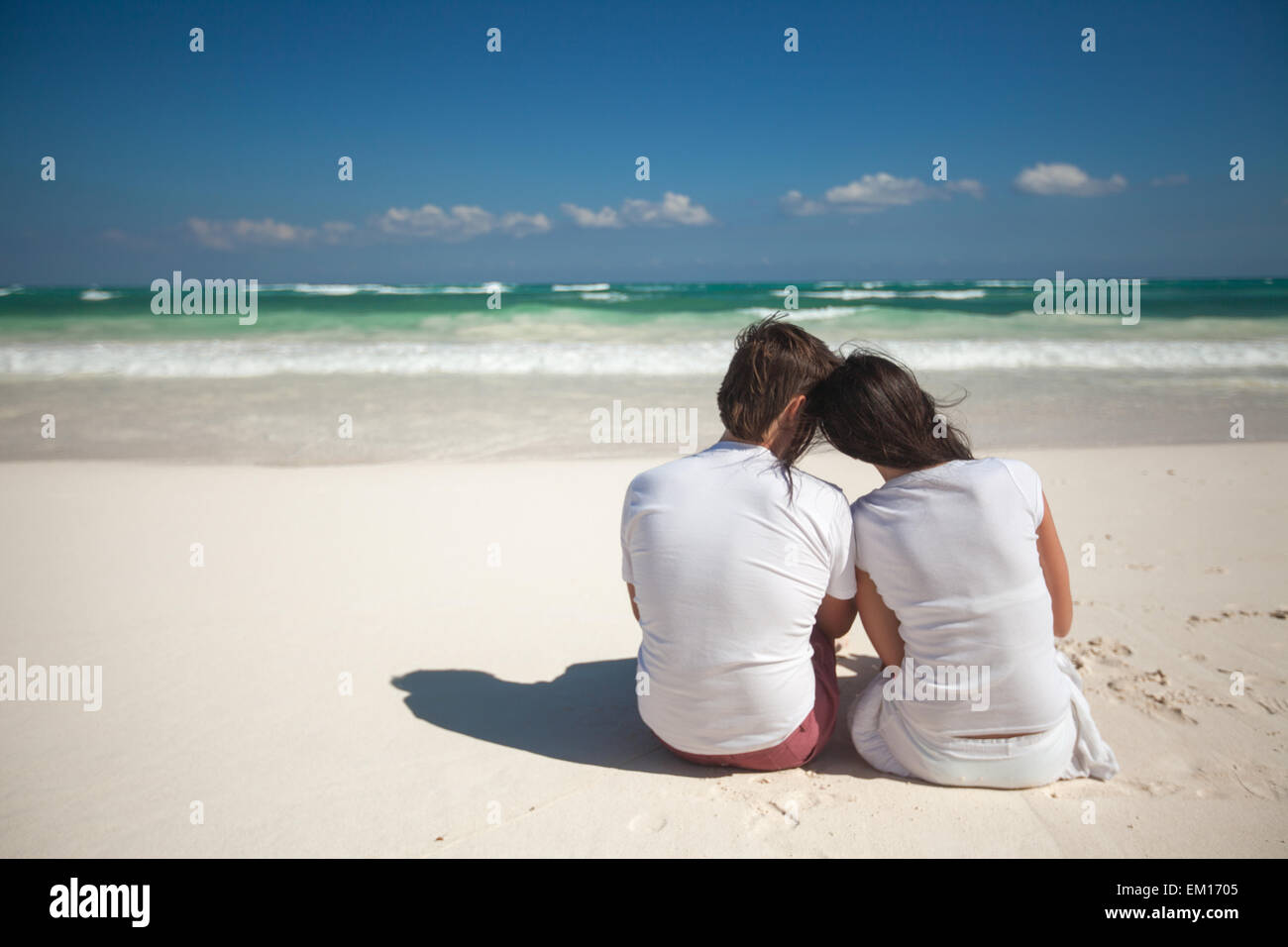 Back view of young couple at tropical white beach Stock Photo - Alamy