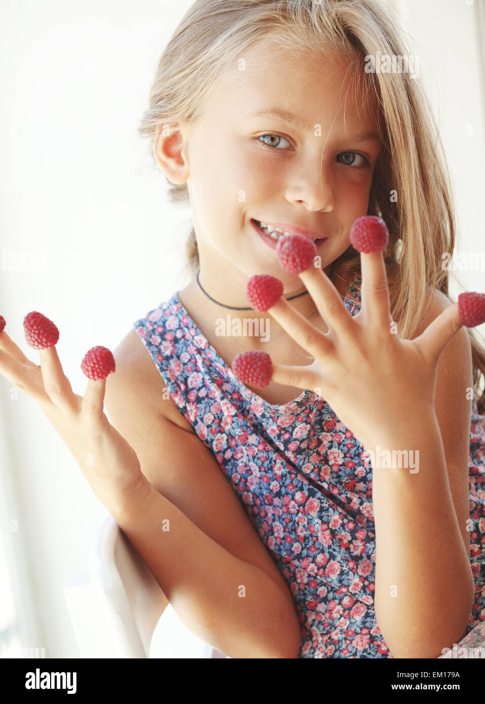 Child eating raspberries Stock Photo - Alamy