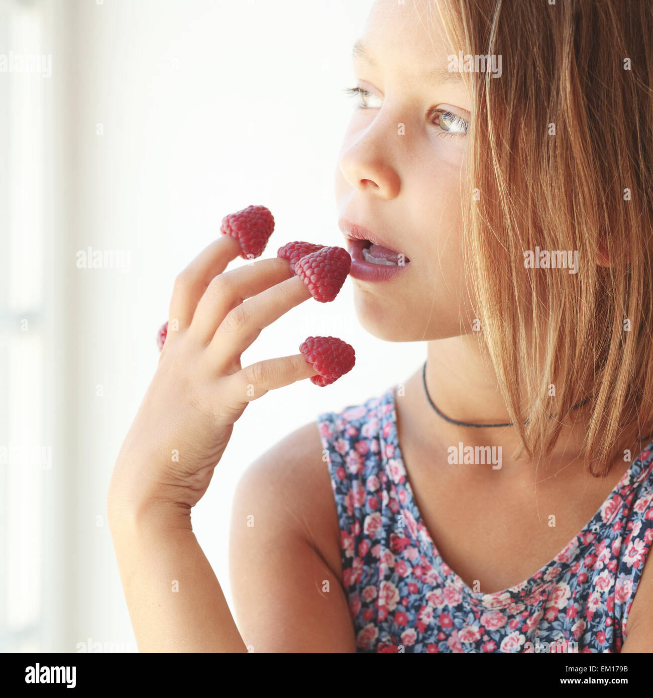Child eating raspberries Stock Photo - Alamy