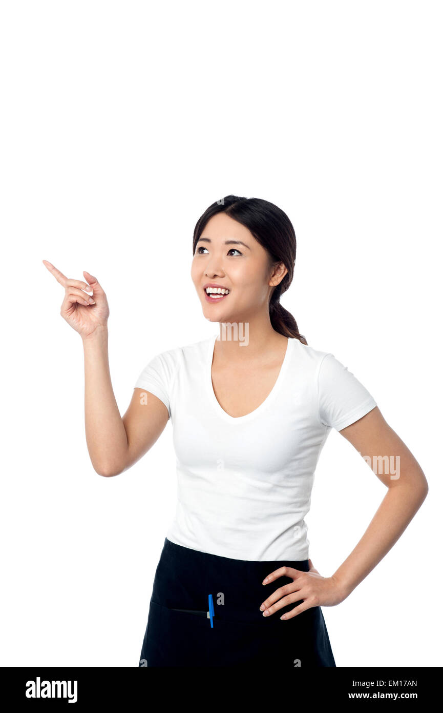 Young woman pointing and looking away Stock Photo - Alamy