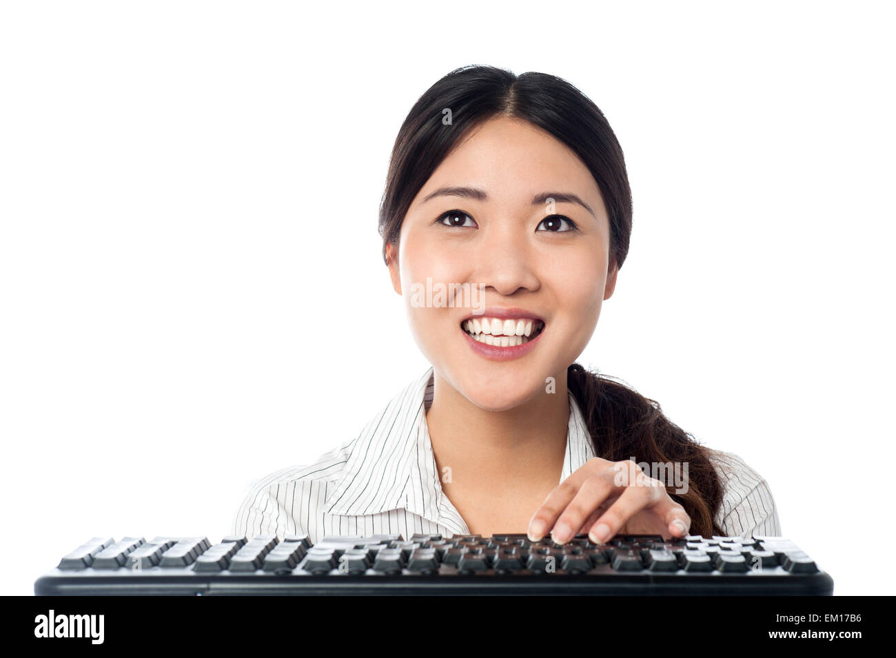 Cheerful girl using computer keyboard to type Stock Photo - Alamy