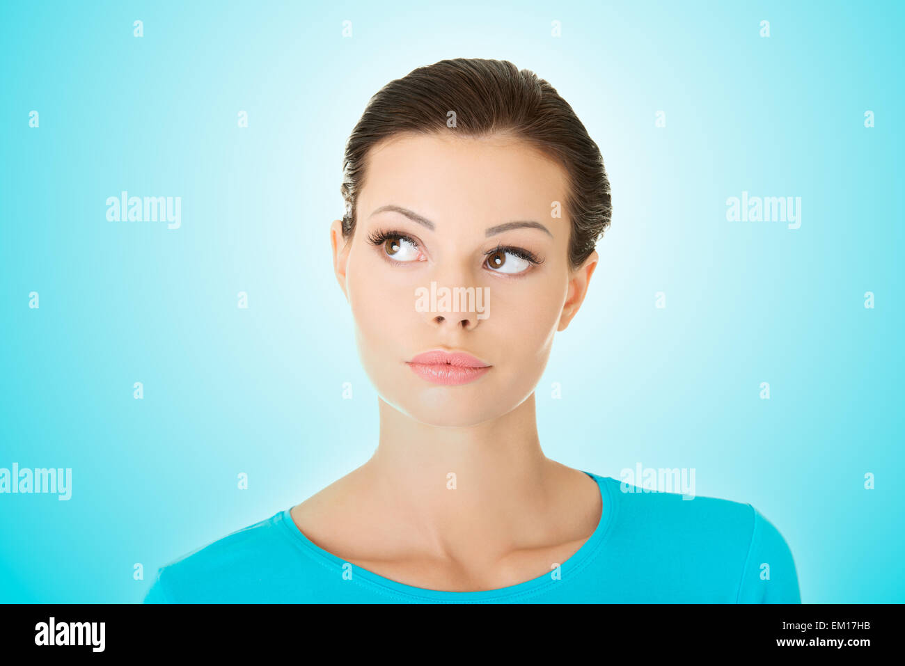 Thoughtful female looking up Stock Photo - Alamy