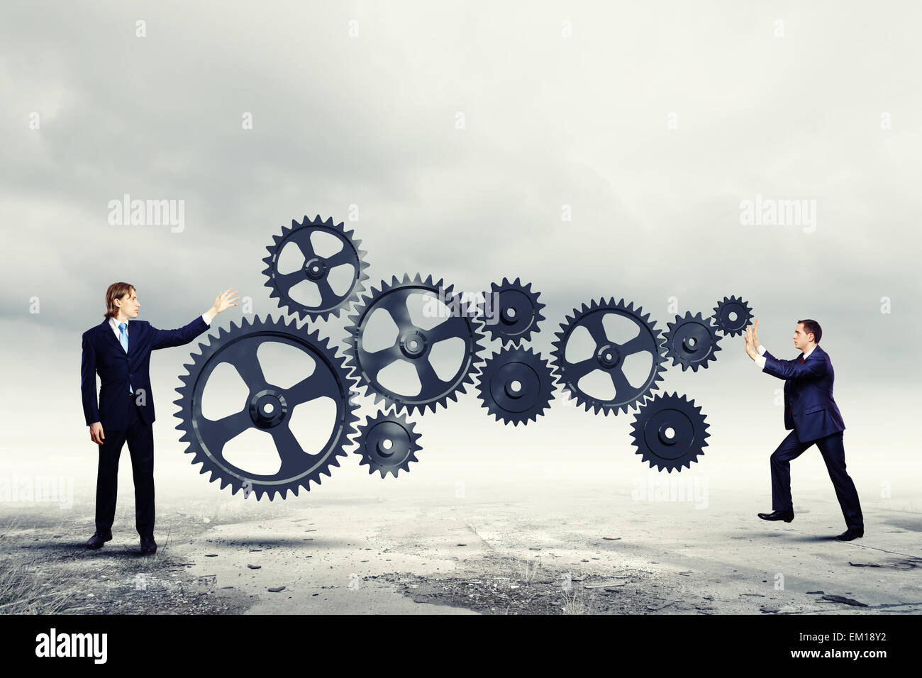 Businessmen and mechanism elements Stock Photo - Alamy