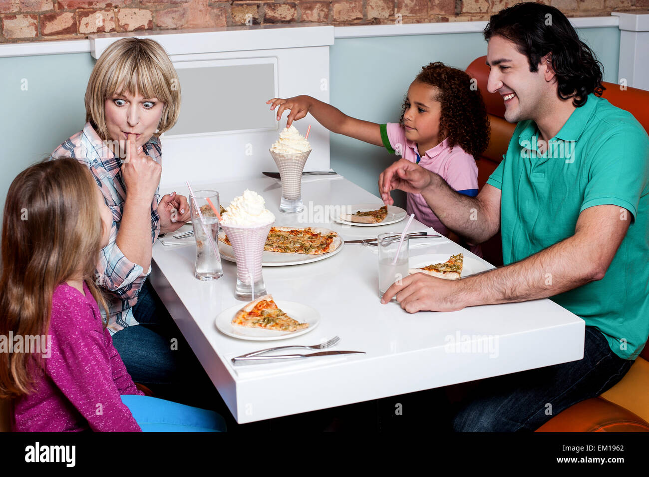 Cheerful family of four enjoying breakfast Stock Photo - Alamy