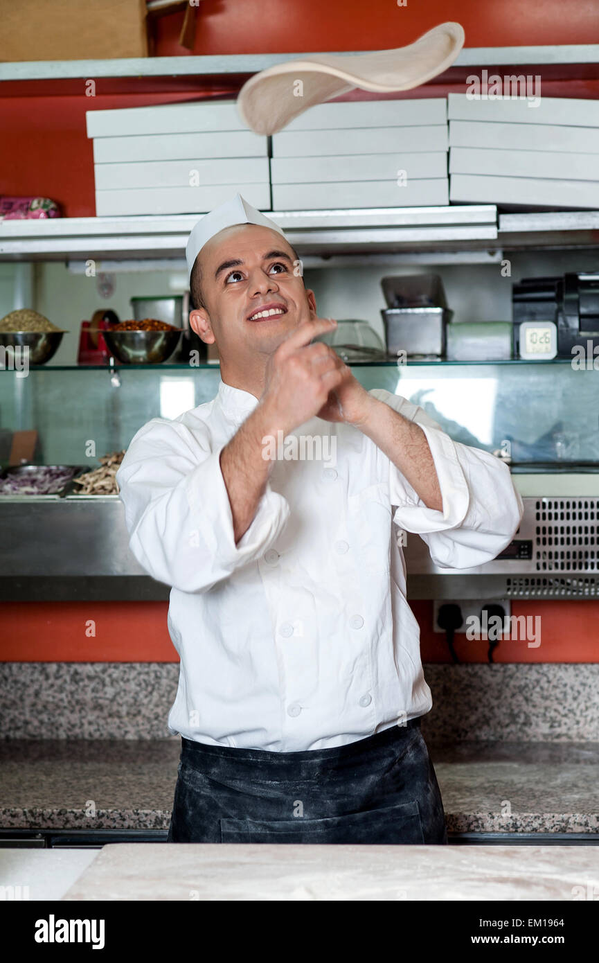 Chef throwing the pizza base dough Stock Photo - Alamy