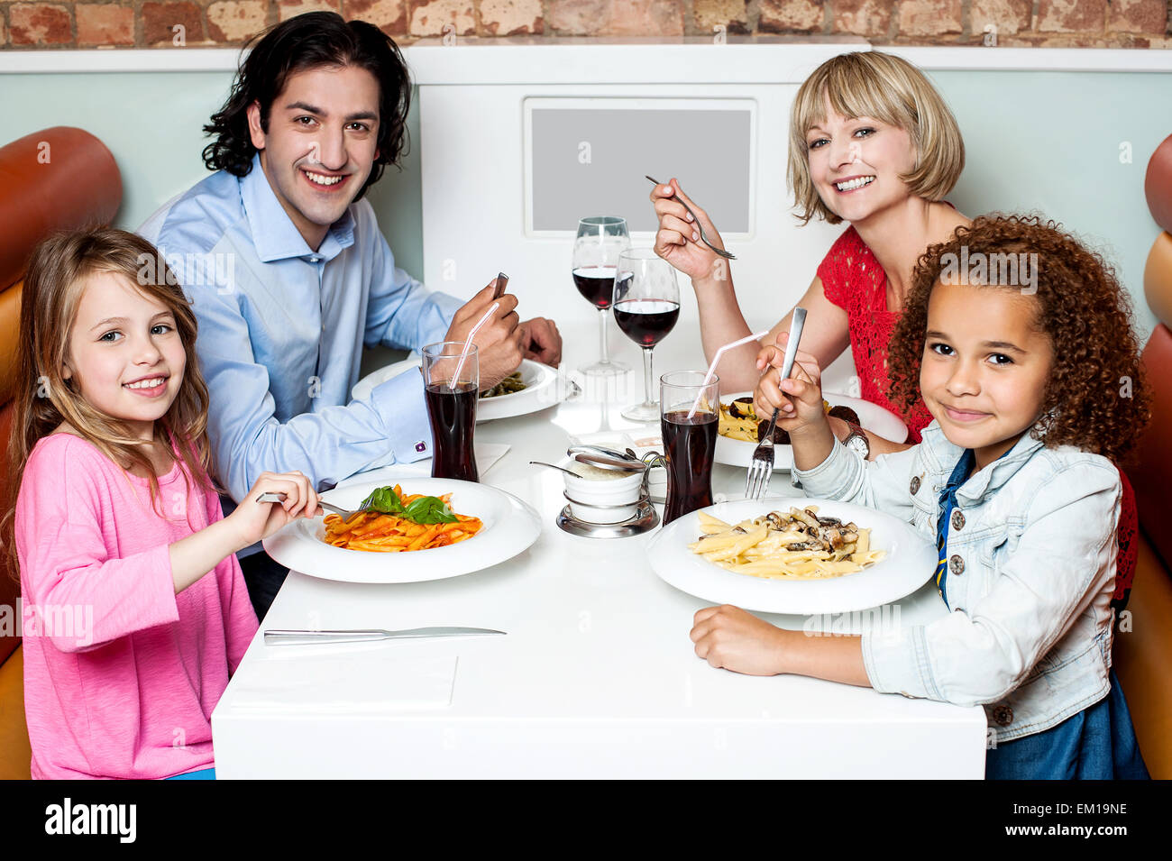 Family eating together in a restaurant Stock Photo - Alamy