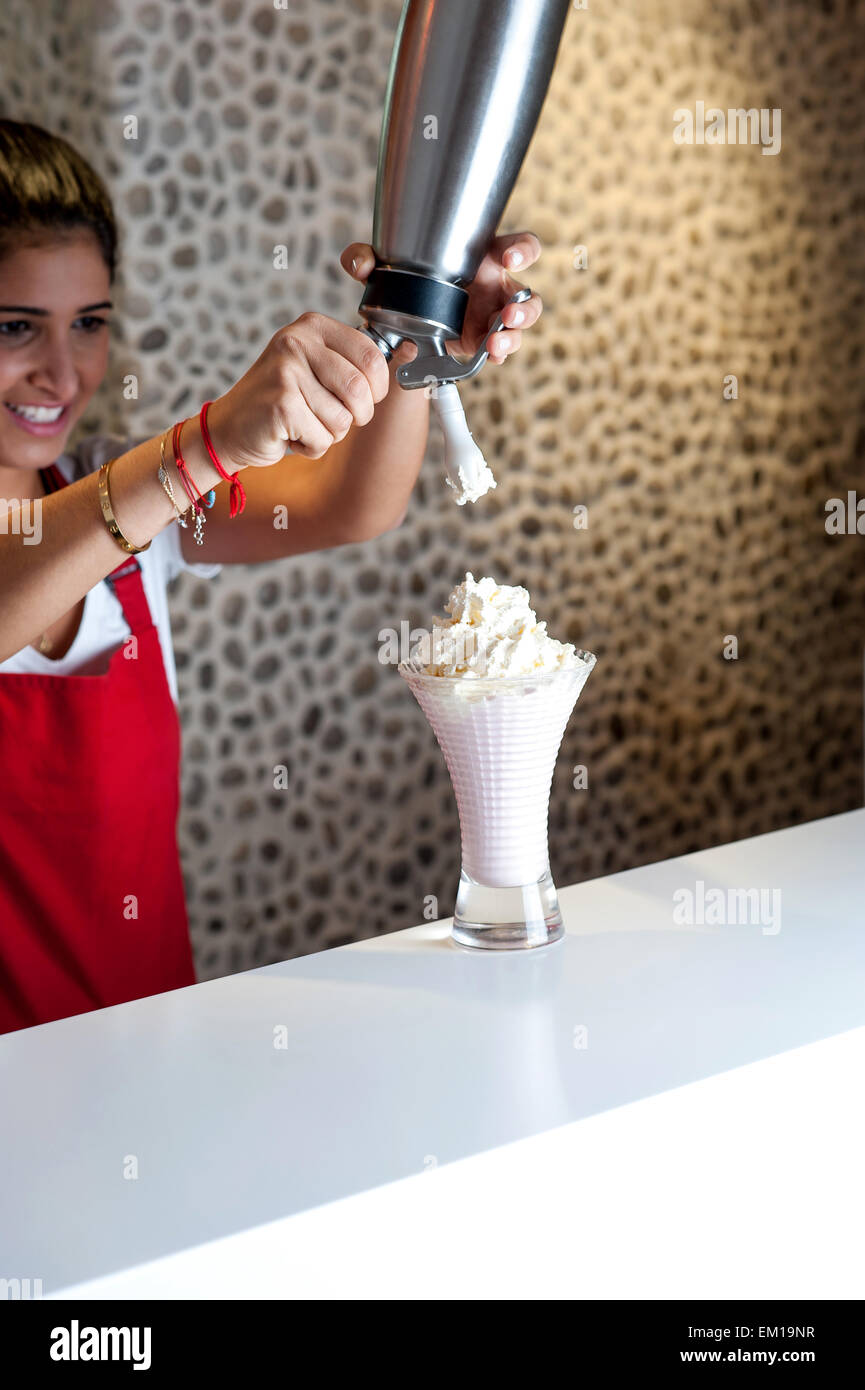 Attractive girl pouring shake in glass Stock Photo - Alamy