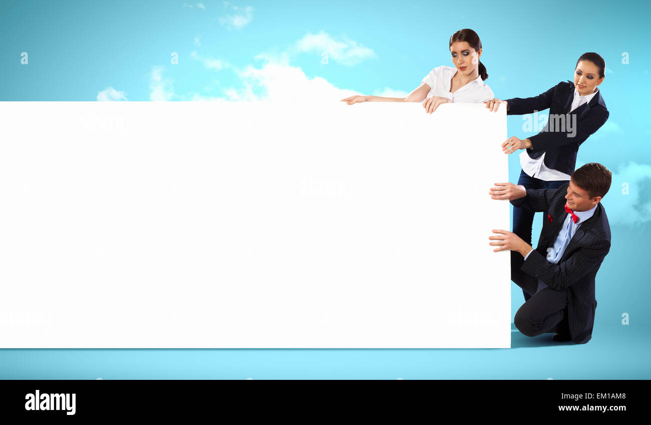 Three young people holding banner Stock Photo - Alamy