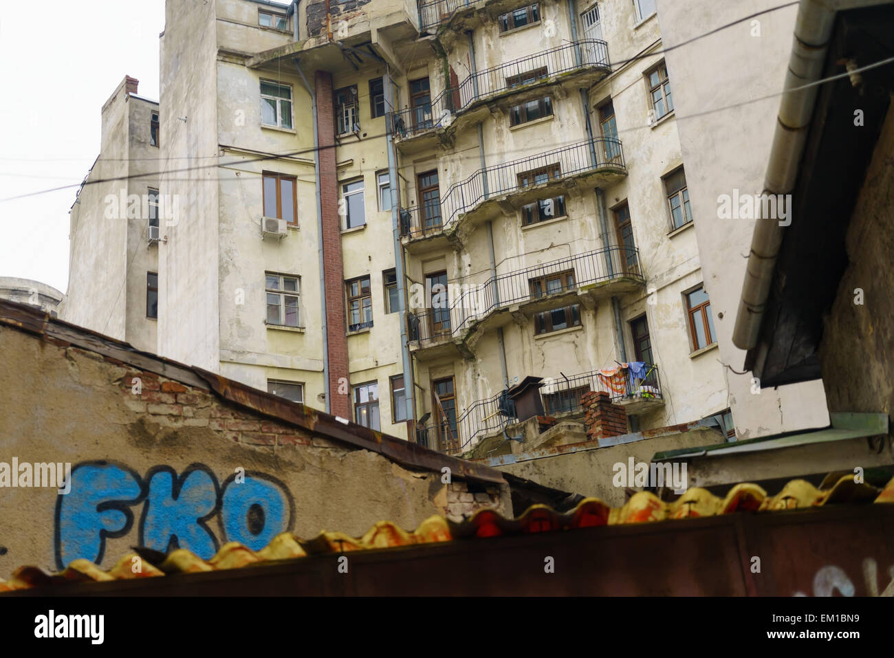 A street and old communist buildings in the city centre of Bucharest ...