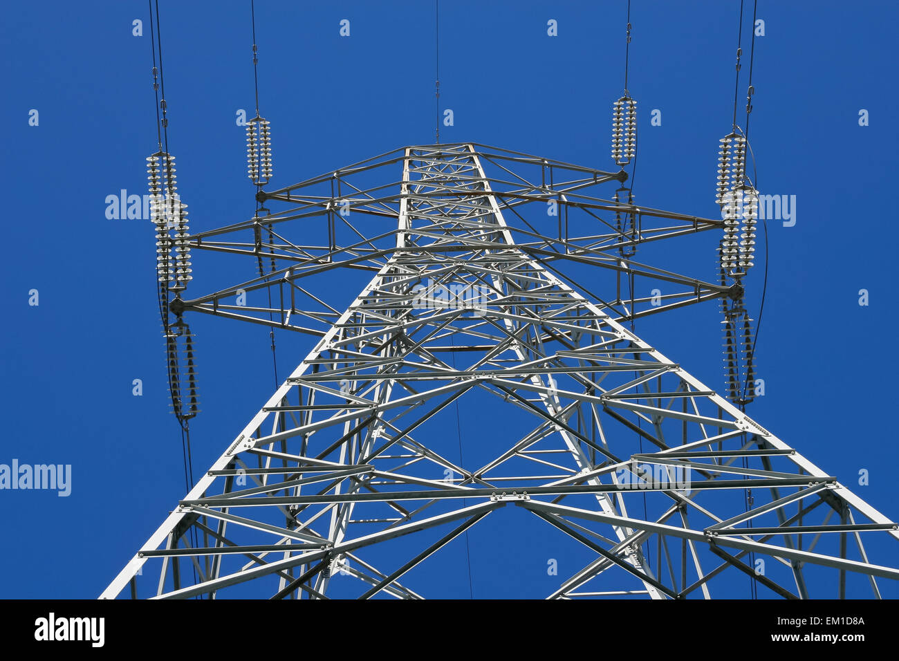 High tension electrical power lines and pylon tower against sky. Modern ...
