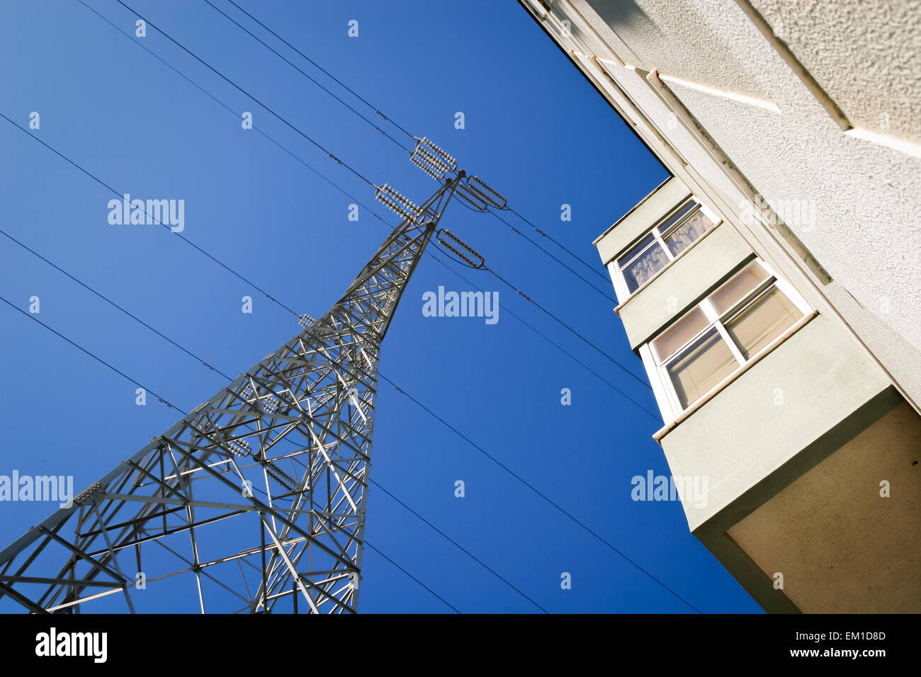 High tension electrical power lines and pylon tower against sky. Modern ...