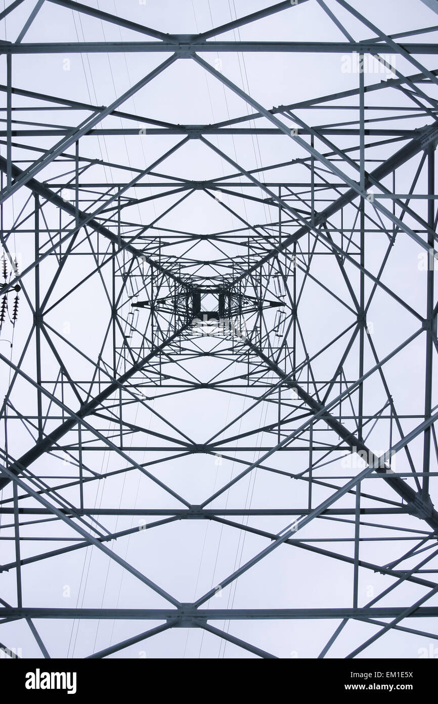 High tension electrical power lines and pylon tower against sky. Modern ...