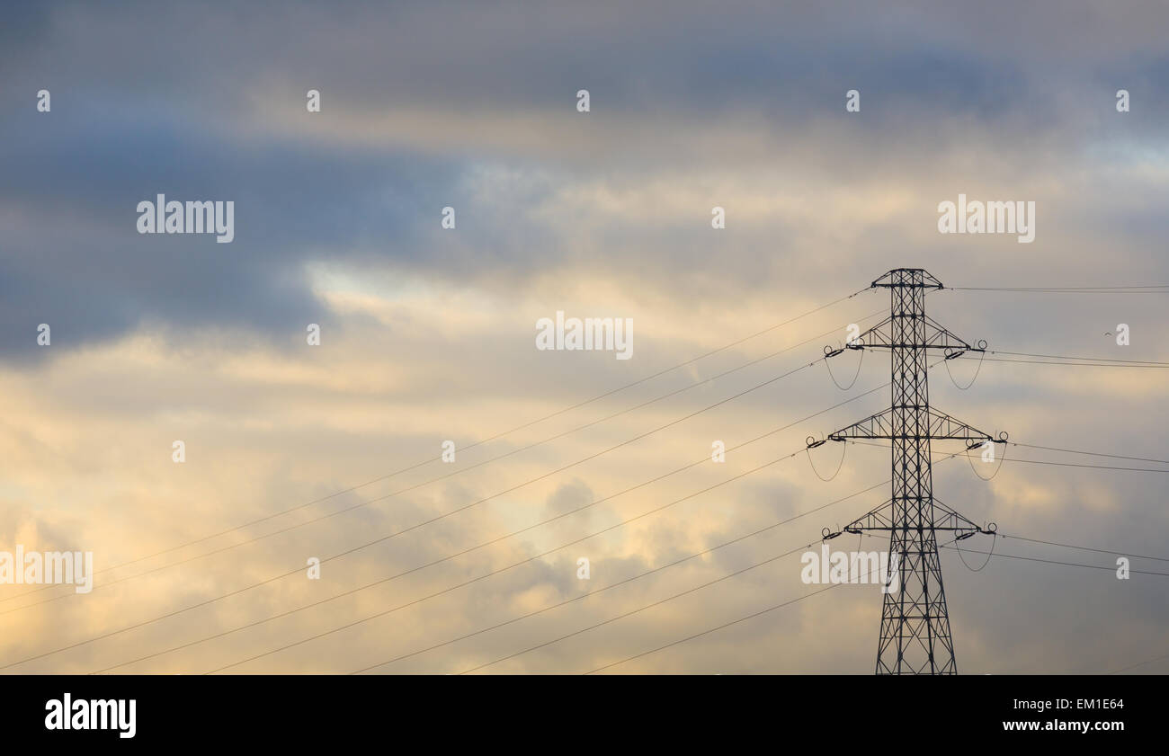 High tension electrical power lines and pylon tower against sky. Modern ...