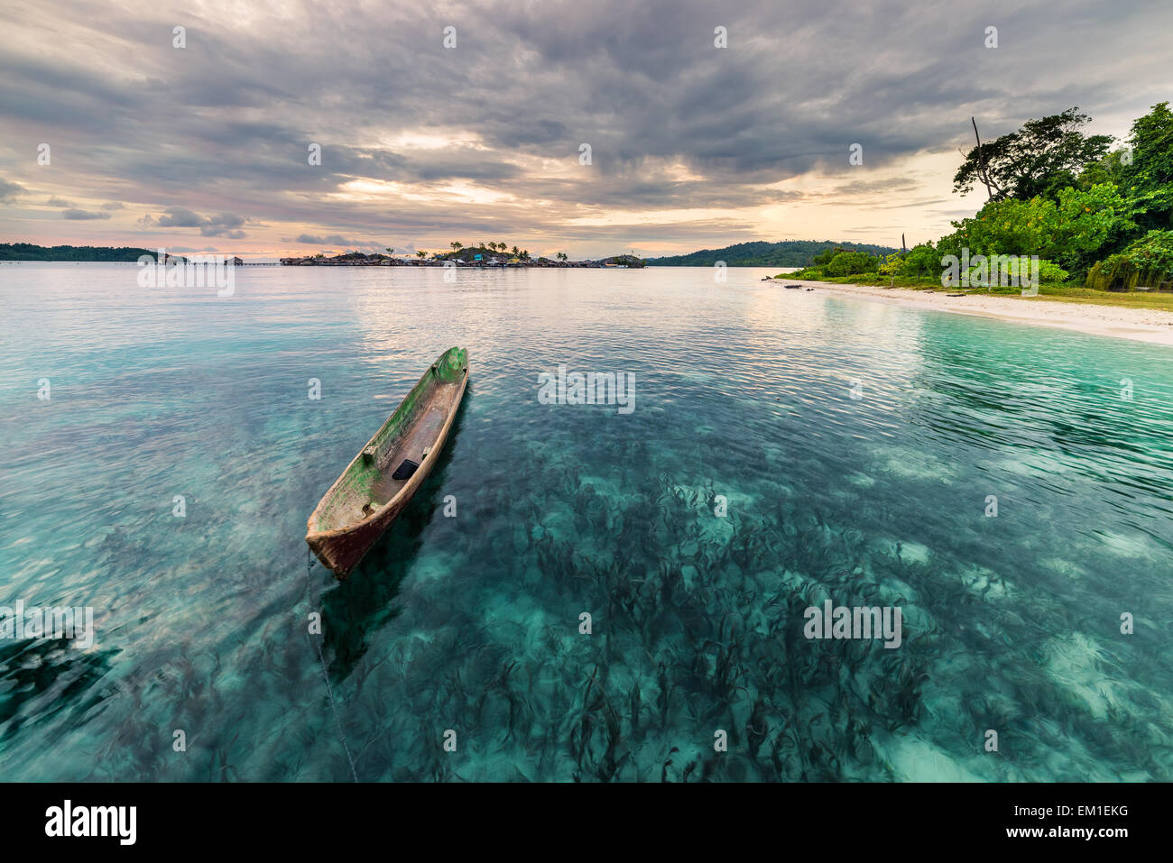 Traditional canoe floating on the transparent turquoise water of ...