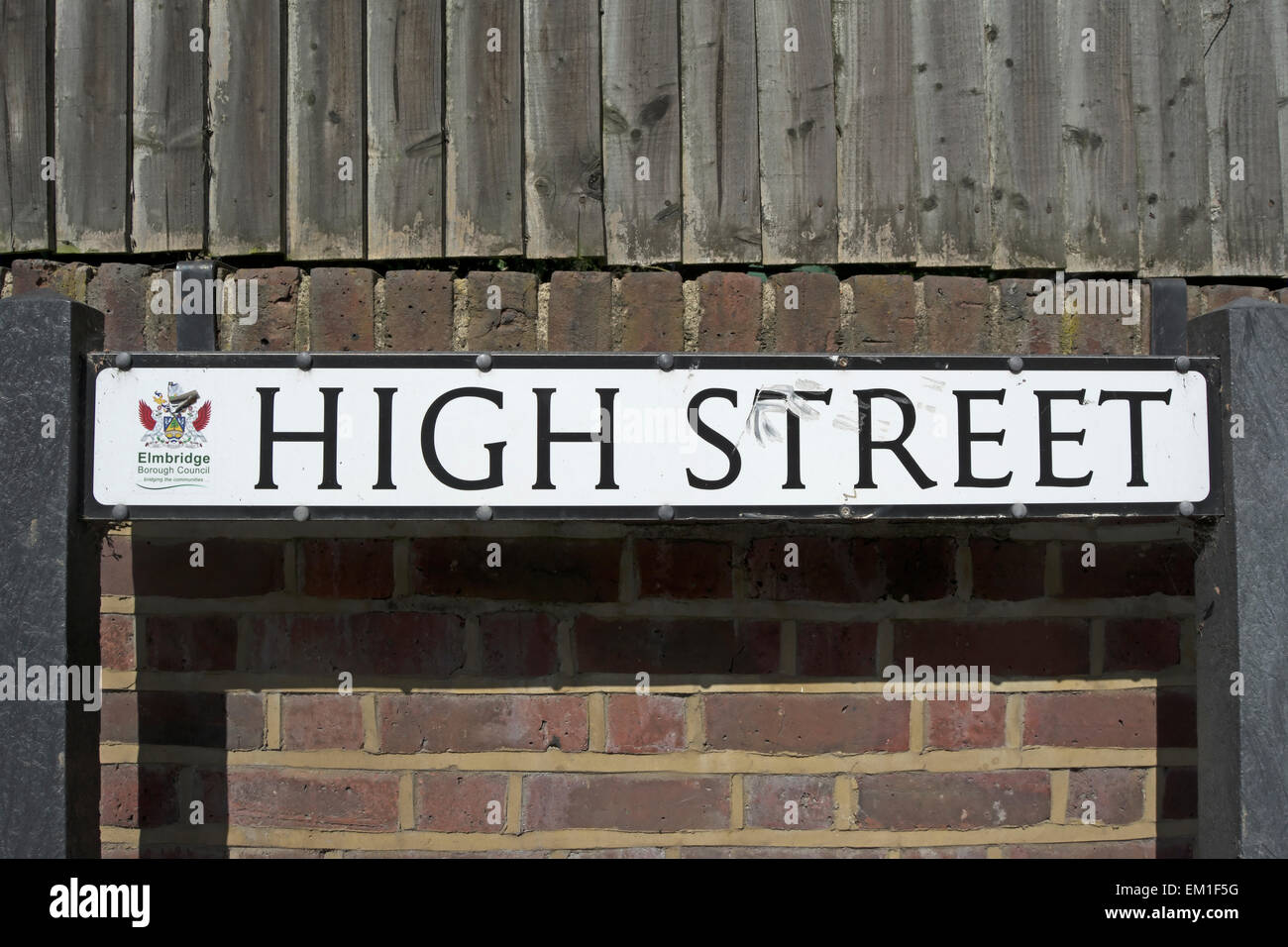 high street street name sign in esher, surrey, england, with crest of ...