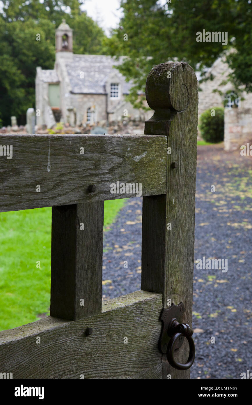 An Open Gate Leading Down A Path To A Cemetery And Church ...