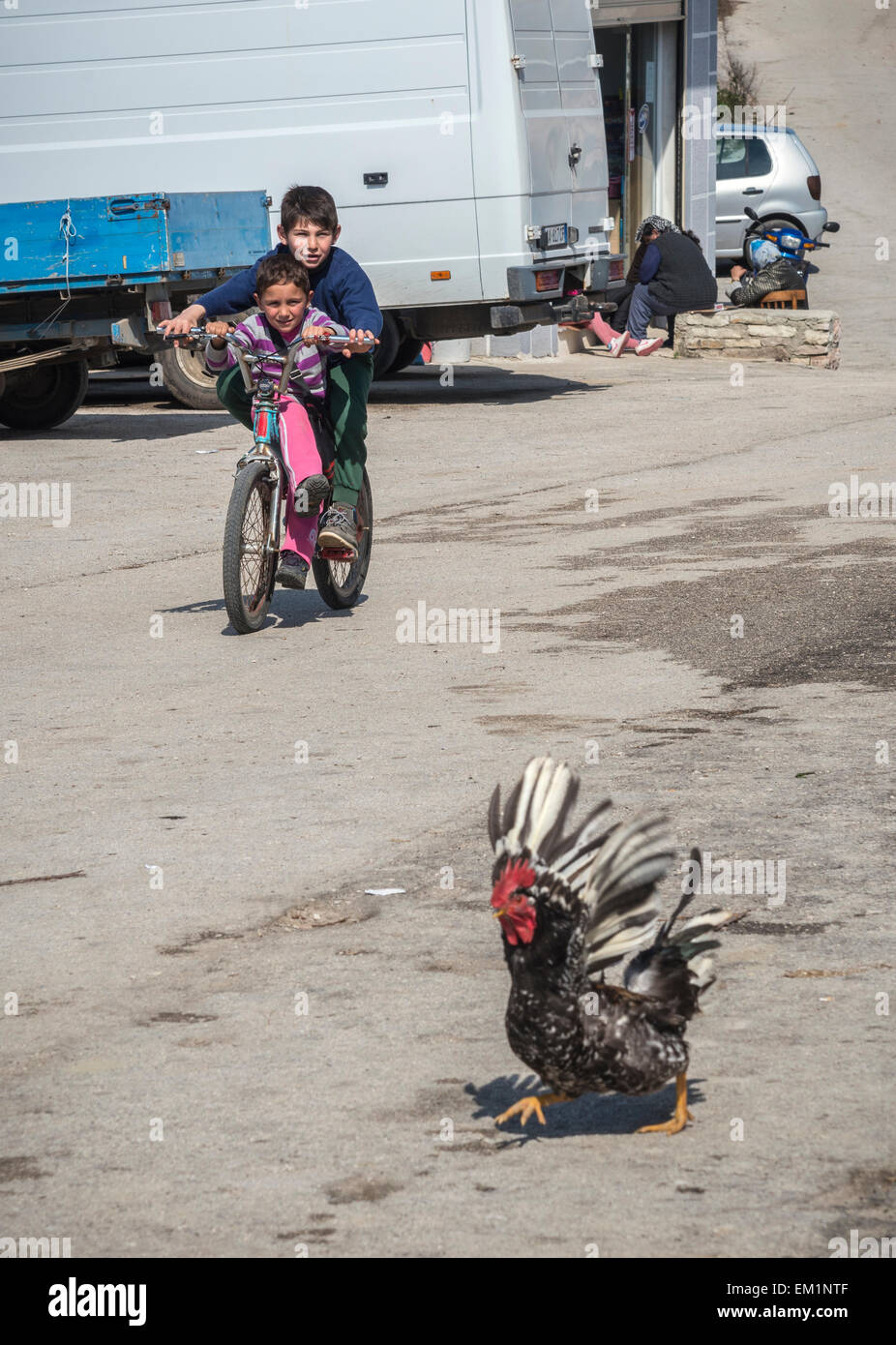 Children chasing chickens in the village of Vrine on the Vrina plain at ...