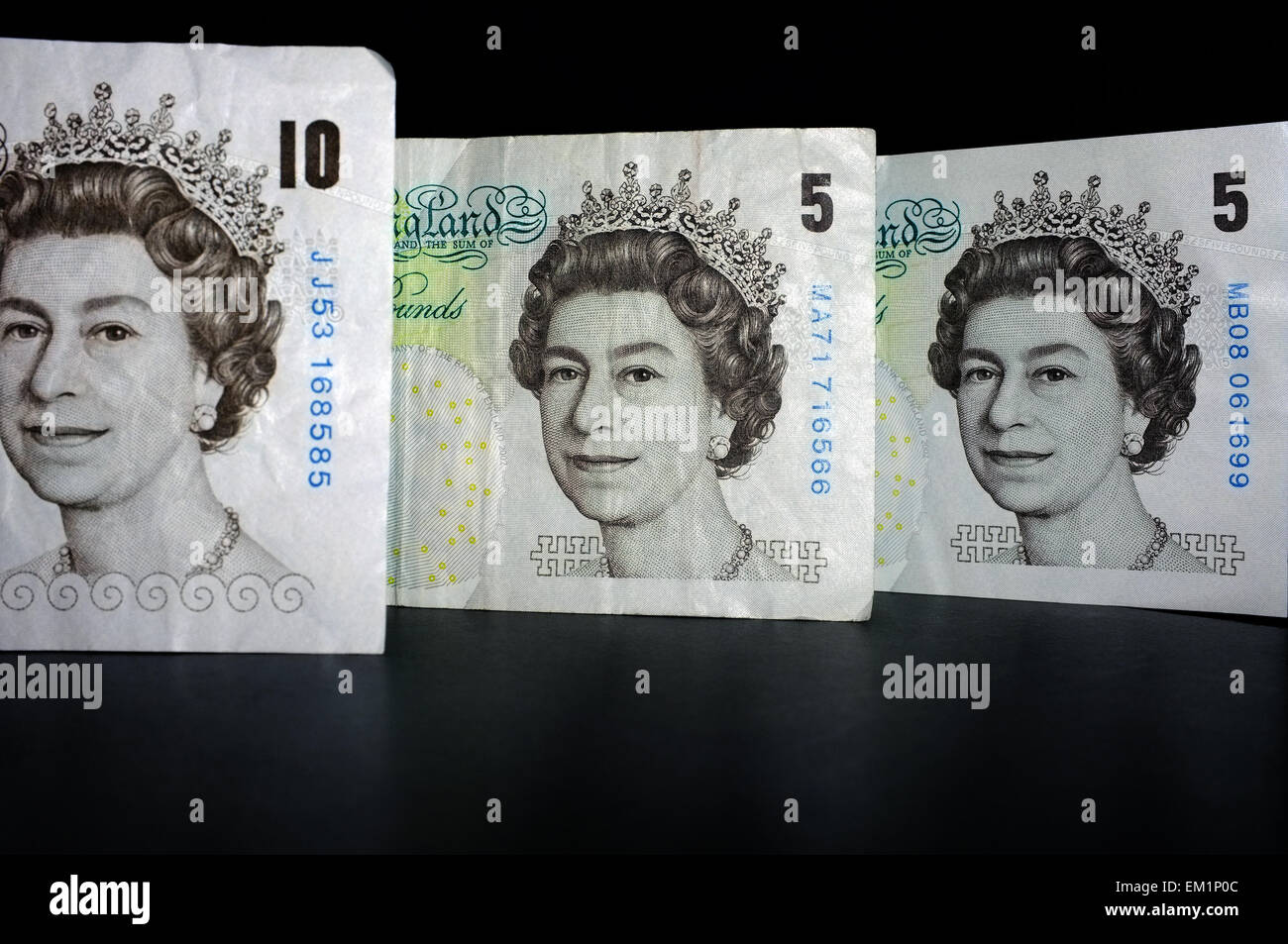 The Queens head on British £5 and £10 notes photographed against a ...