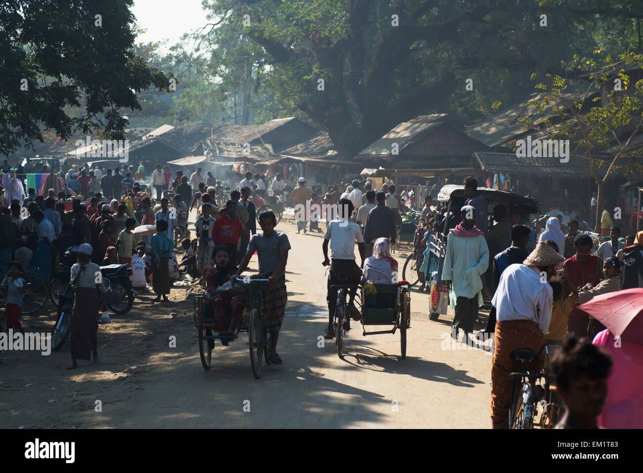 Pedicabs and pedestrians on a busy street; Sittwe, Rakhine State, Burma ...