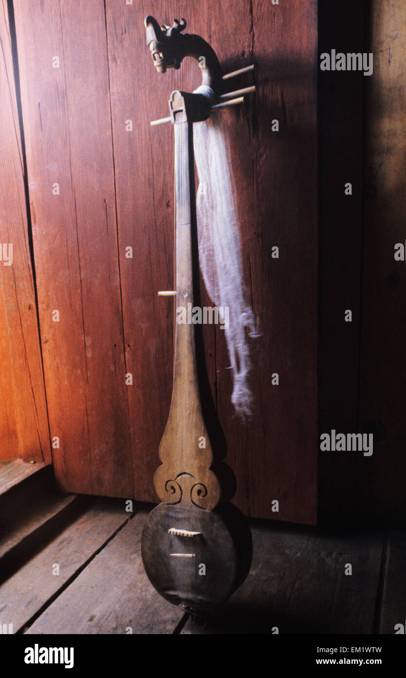 Dranyen leaned against wooden wall; Bhutan Stock Photo - Alamy