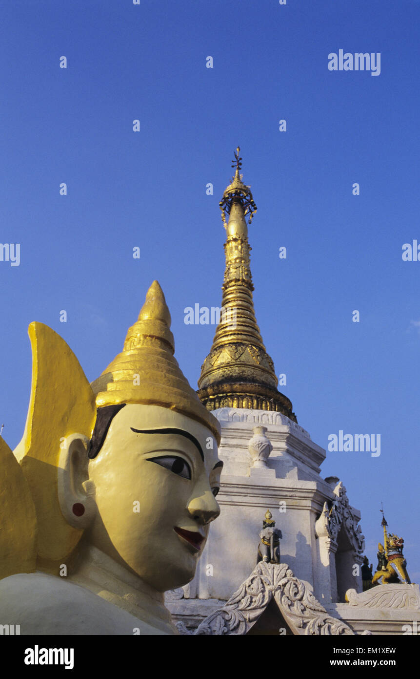 Burma (Myanmar), Yangon, Close-up of Buddha statue and top of temple ...