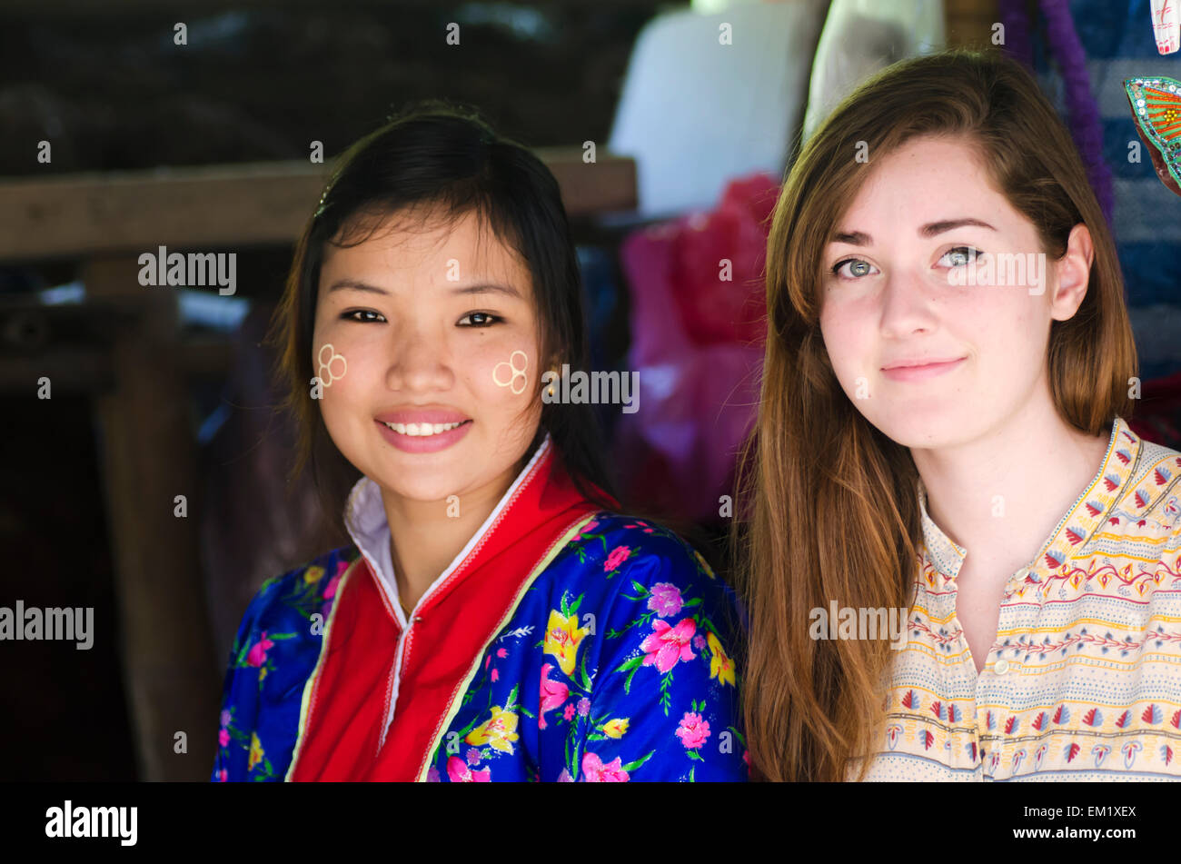 Karenni girl and a western girl in a village in the golden triangle; Thaton, Chiang Rai ...
