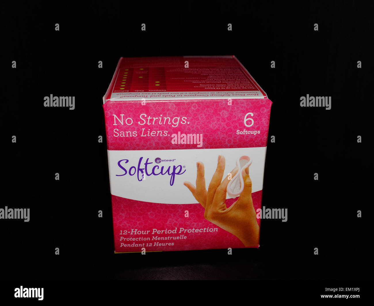 A box of Softcup flexible period cups photographed against a black ...