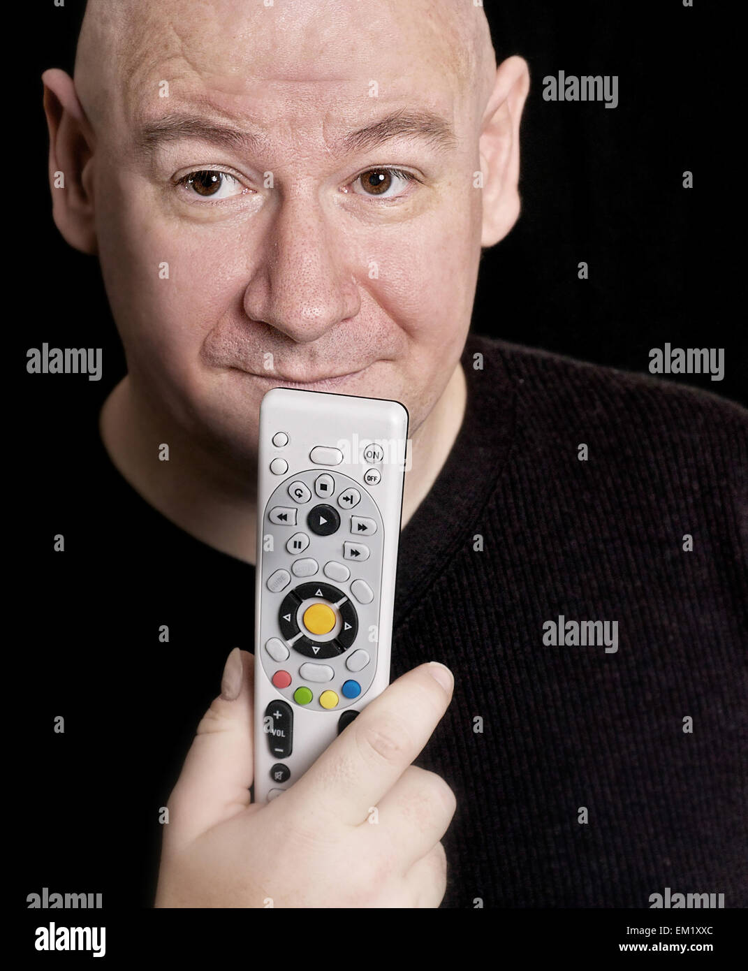 Man holding tv remote control Stock Photo - Alamy
