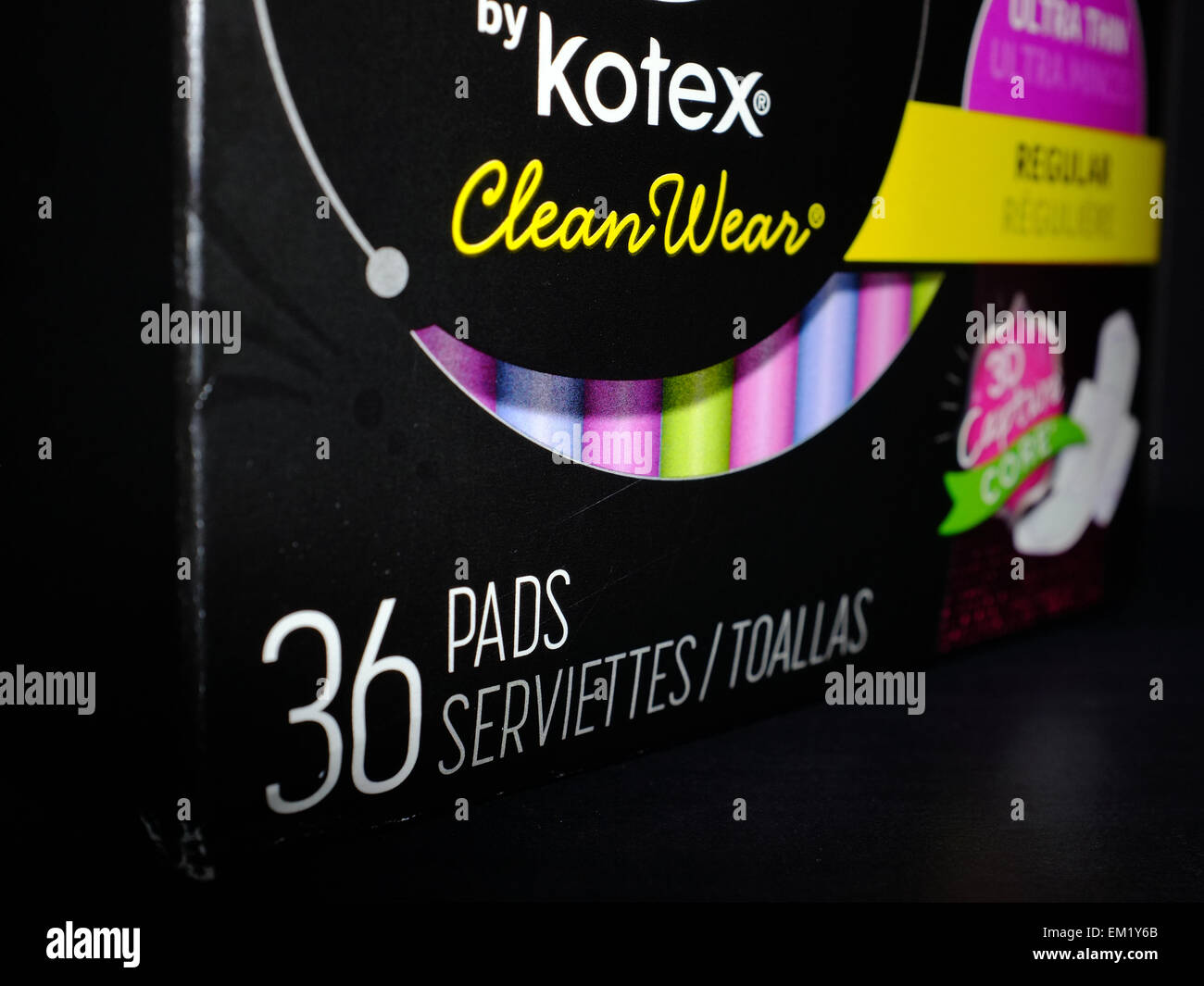 A packet of thin sanitary pads photographed against a black background ...