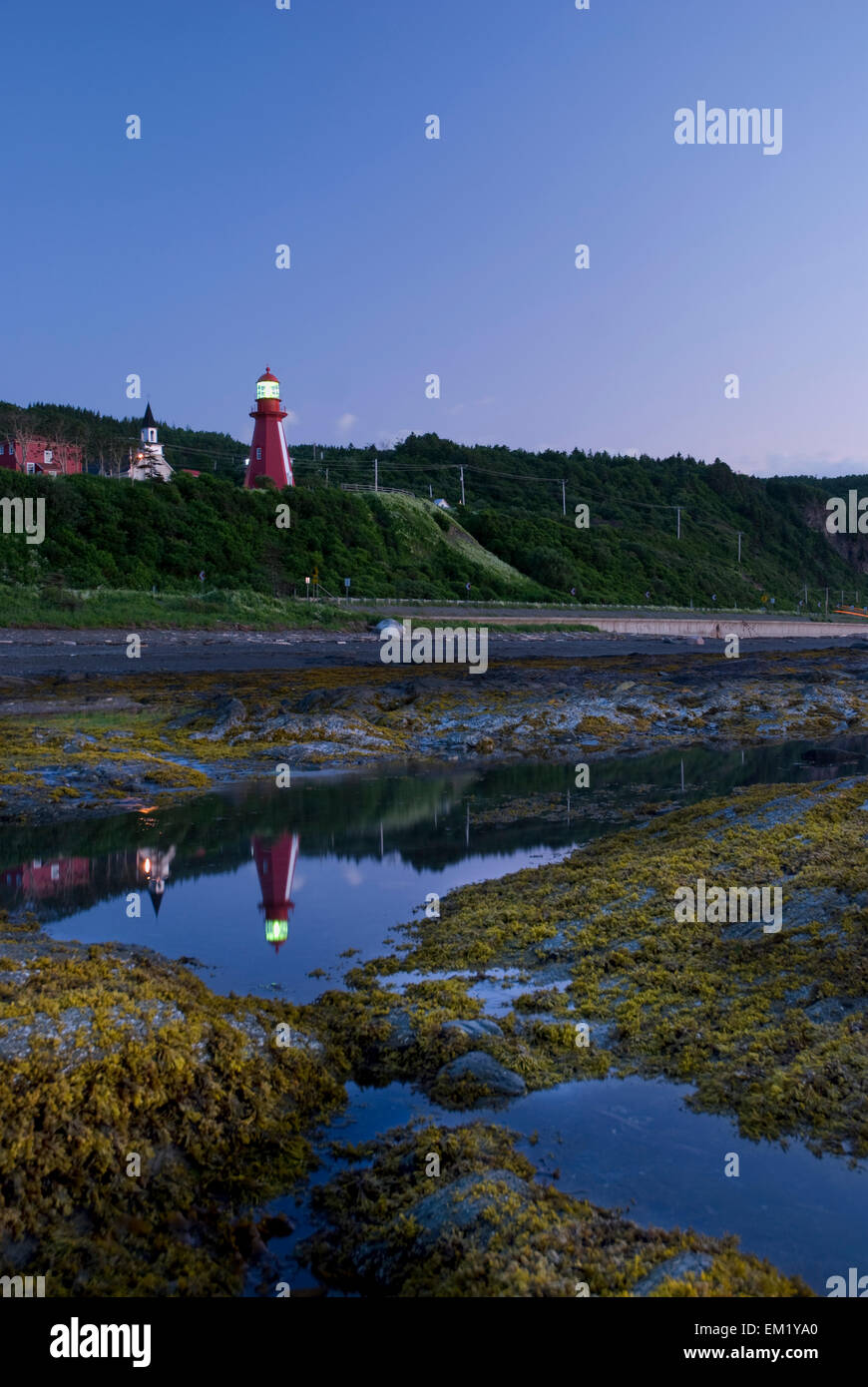 Red Lighthouse Reflecting In A Beach Pool; La Martre Quebec Canada ...