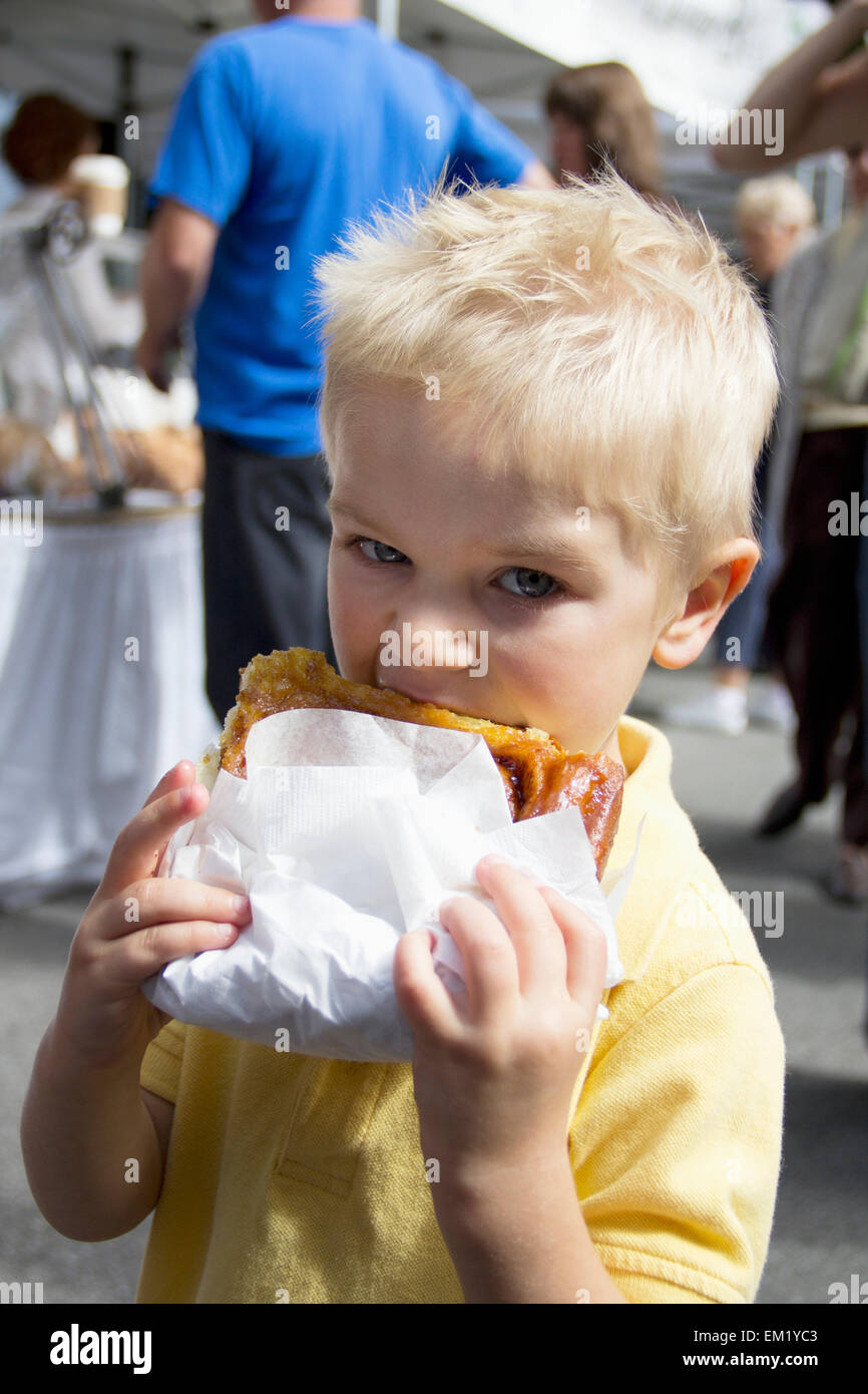 Young Boy Eating Pastry; Ladner British Columbia Canada Stock Photo - Alamy