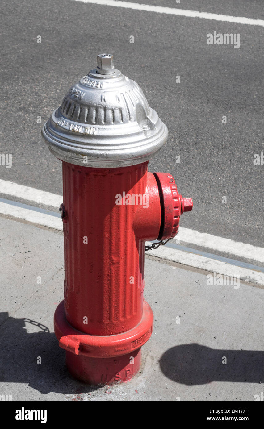 A red painted fire hydrant on the sidewalk on a street in New York City ...