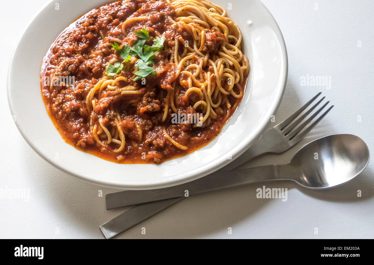 Spaghetti Bolognese in white bowl on a white table Stock Photo - Alamy