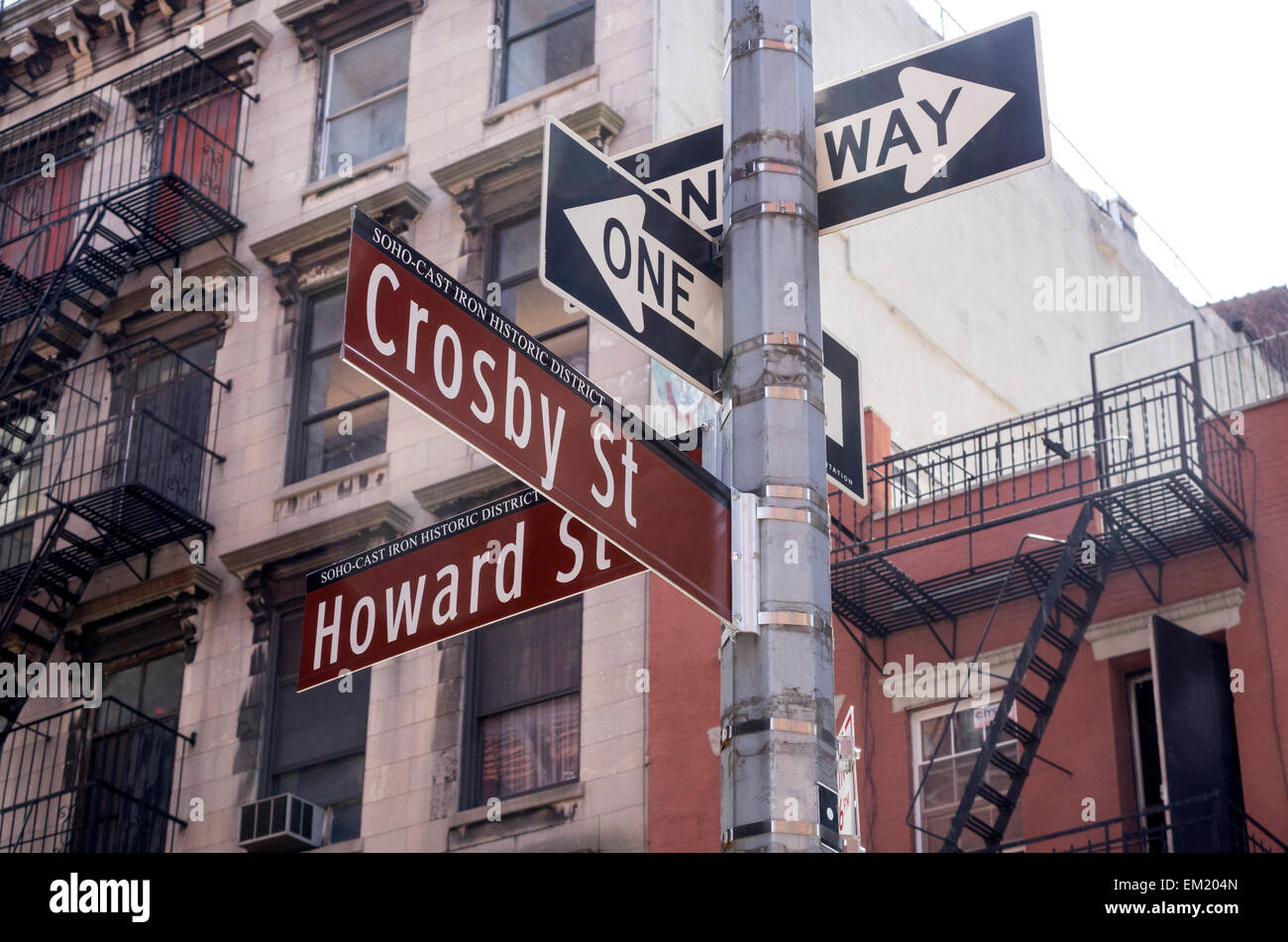 Street signs in the cast iron district of Soho in New York City. Street ...